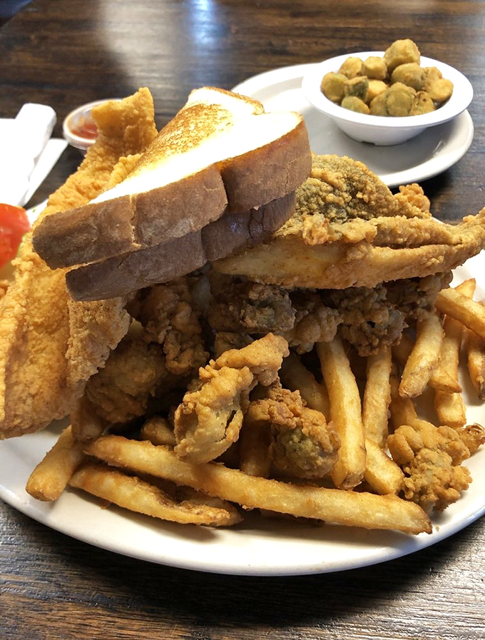 A seafood combo plate that makes sharing impossible. Notice how there's just enough fries to feel virtuous about eating vegetables.