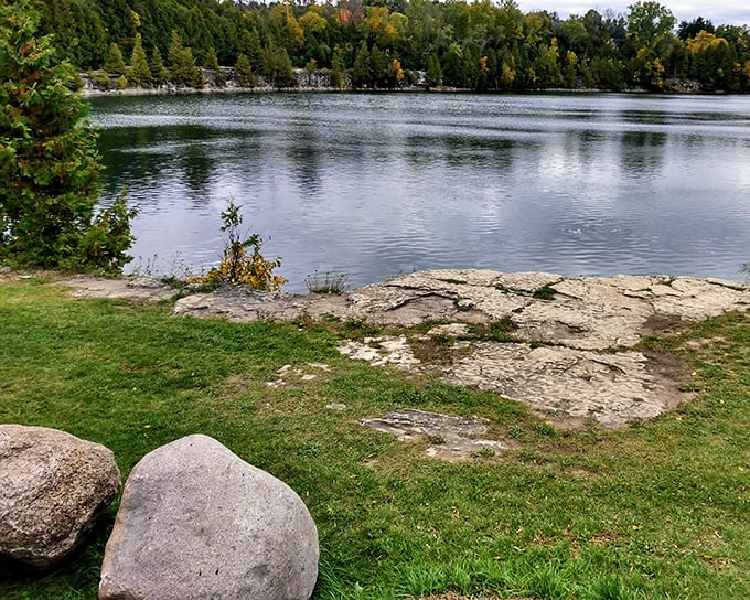 Fall colors frame this serene lake view, where the water mirrors the sky in a perfect moment of Midwestern tranquility.