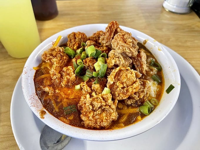 Crispy fried shrimp nestled in cheesy grits with scallions standing guard. Southern coastal comfort in every spoonful.