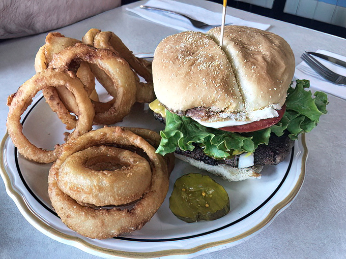 This burger doesn't need fancy aioli or artisanal buns to impress&mdash;just honest ingredients, proper execution, and those onion rings that shatter satisfyingly with each bite.