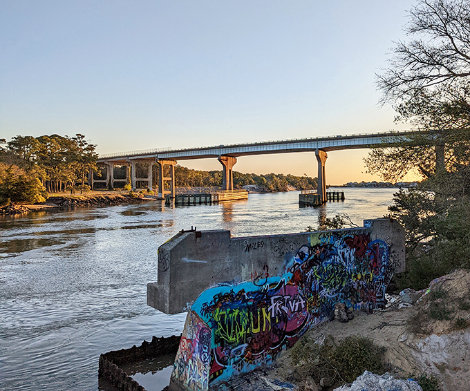 The Snow Cut waterway at golden hour, where concrete meets nature with surprising harmony and even graffiti adds character.