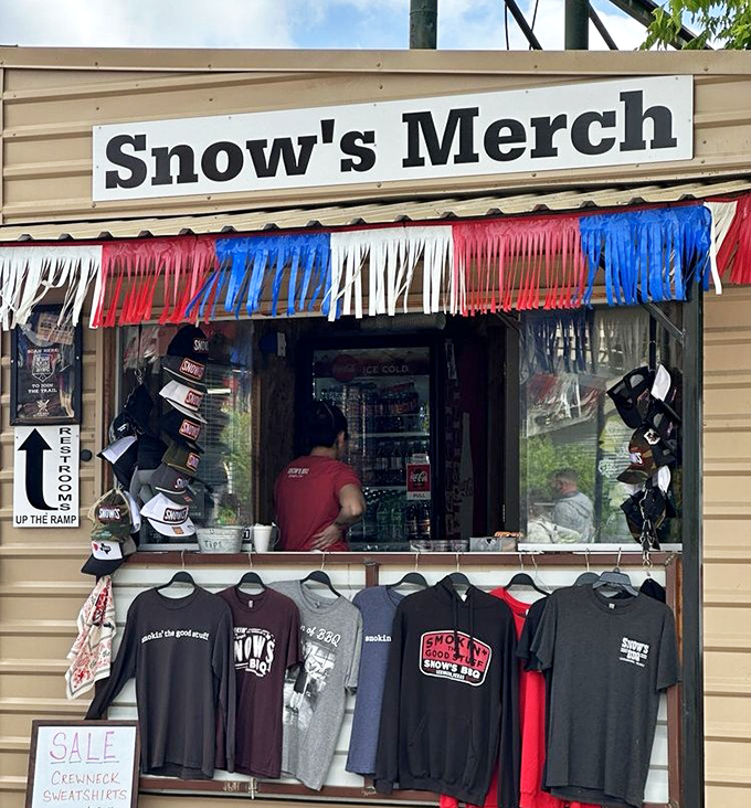 The merch stand—because the only thing better than eating at Snow's is wearing the evidence that you've made the pilgrimage to this barbecue mecca.