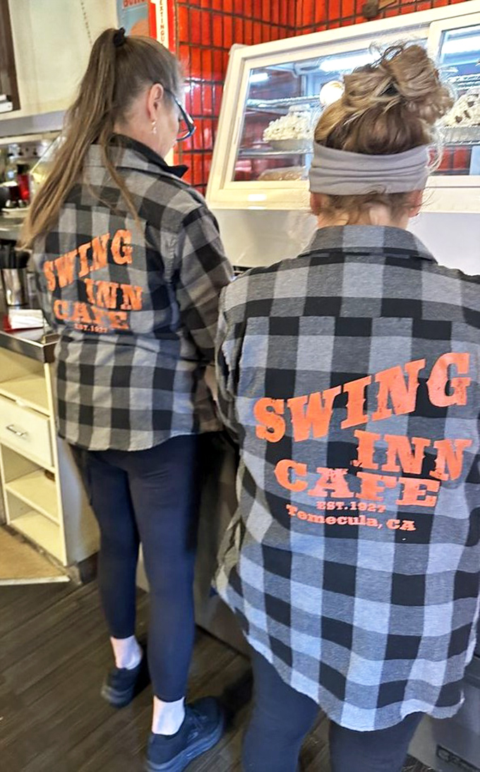 The plaid-clad staff sporting their Swing Inn pride&mdash;these folks aren't just servers, they're keepers of the flame.