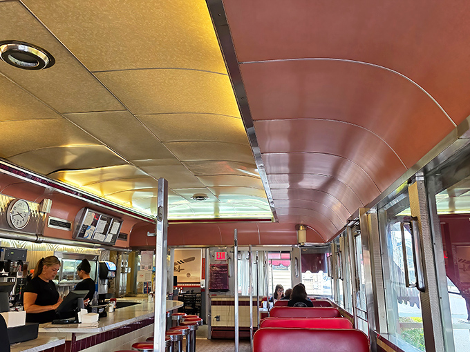 The curved ceiling and classic diner layout create a cozy capsule where time slows down just enough to savor both your meal and the moment.