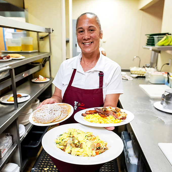 The wizard behind the breakfast curtain, proudly displaying her morning masterpieces. Those plates tell the whole story.