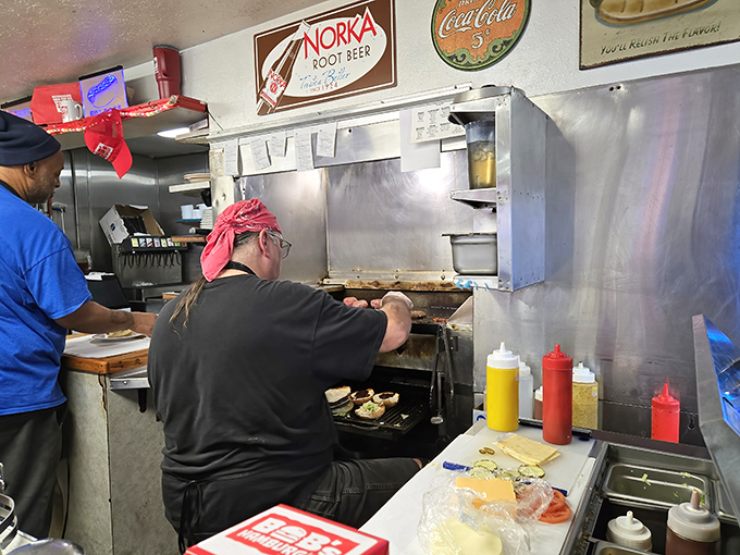 The maestro at work. That red bandana might as well be a Michelin star when you've been perfecting burger technique for decades. 