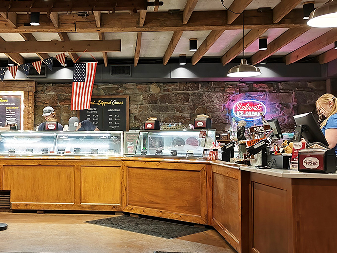 Behind this counter, ice cream artists work their magic. The neon sign glows like a beacon for sweet-toothed pilgrims.