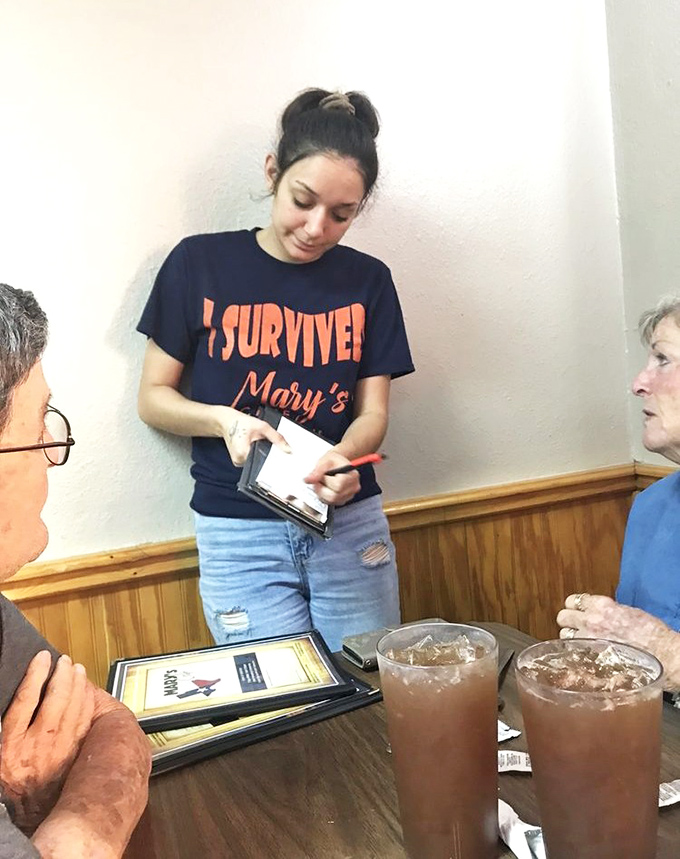 The "I Survived" shirt says it all. Mary's servers are the guardians of a culinary tradition that's bigger than any one meal.