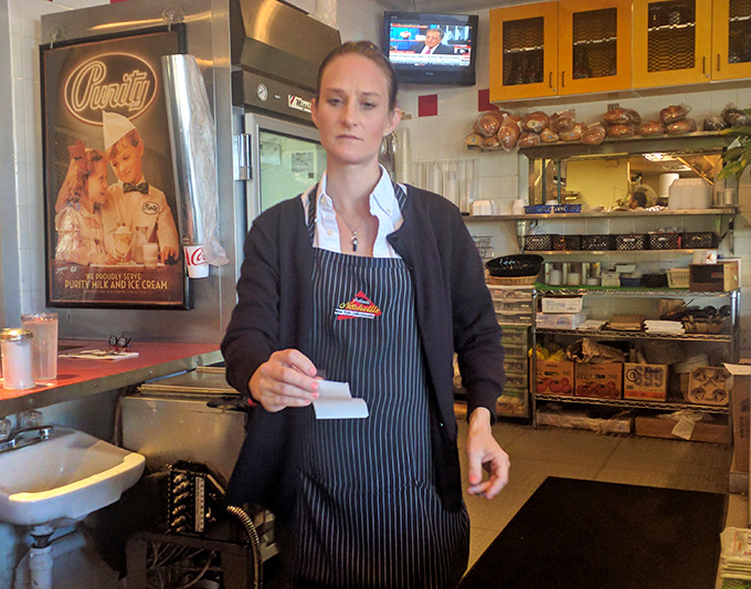 Dedicated staff member ensuring every order meets the exacting standards this place is known for.