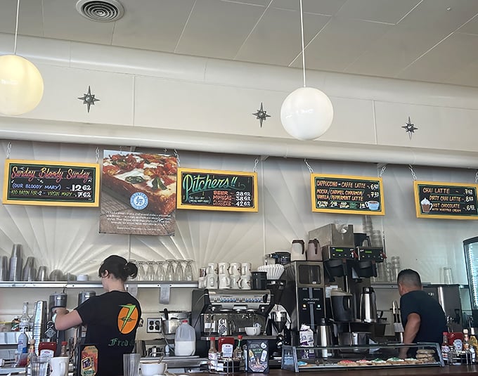 Behind the counter, culinary choreography unfolds as the kitchen crew works their 24-hour magic.