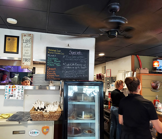 The specials board holds today's surprises while staff members orchestrate the morning rush. This is where breakfast dreams are born and hangovers go to die.