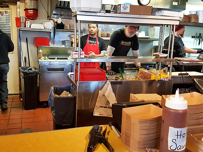 The magic happens behind this counter, where pit masters orchestrate a symphony of smoke and meat with practiced precision.