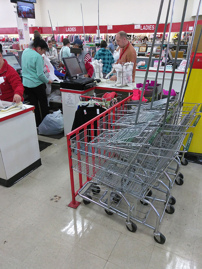 The unsung heroes of thrift—staff members efficiently processing purchases while shoppers clutch their treasures with the glee of successful hunters.