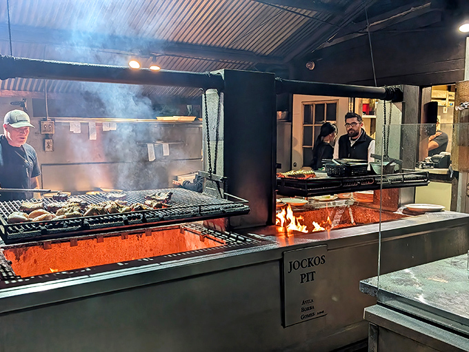 The open flame isn't just for show&mdash;it's the beating heart of Jocko's. That smoke carries decades of culinary wisdom.
