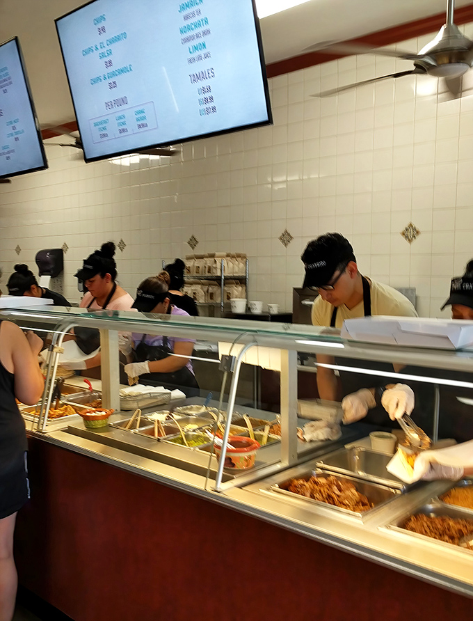 The kitchen crew moves with the practiced choreography of people who've made thousands of perfect burritos without losing their passion.