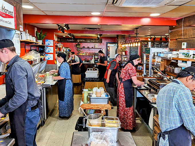 Where the magic happens&mdash;staff members working with purpose and passion in a kitchen that feels like the heart of the caf&eacute;.