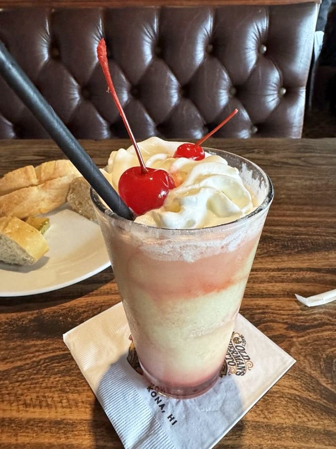 The strawberry colada arrives like a dessert in disguise, topped with whipped cream and cherries. Vacation in a glass, no plane ticket required.