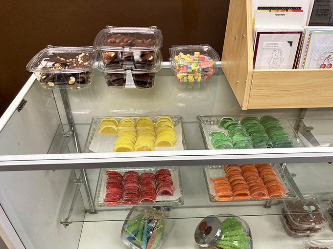 A rainbow of sugar-dusted jellies and Buckeyes waiting to be boxed – proof that eating with your eyes happens before the first bite.