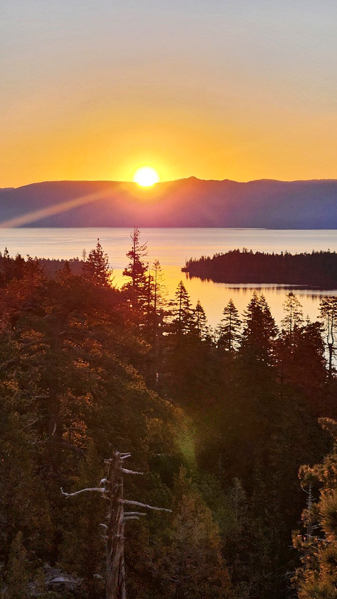 Sunset symphony: Golden hour transforms Emerald Bay into a painter's palette of warm hues, proving that Mother Nature is the ultimate Instagram influencer.