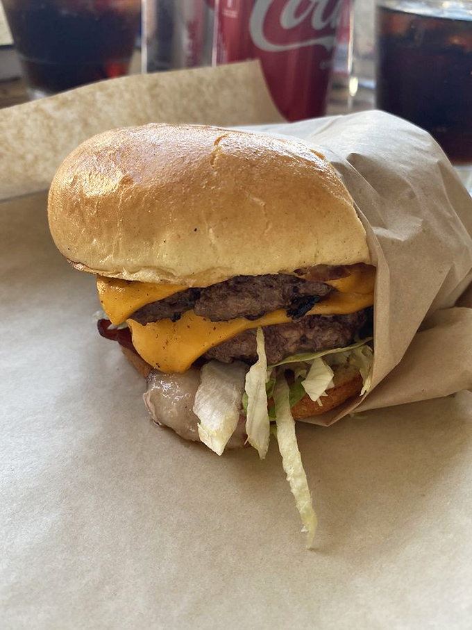 The American burger, wrapped in paper like the gift it is. Those two patties with melted cheese are conducting a symphony of flavors.