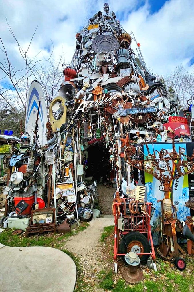 The towering spire reaches skyward like a prayer made of bicycle parts, kitchen appliances, and the collective nostalgia of several decades.
