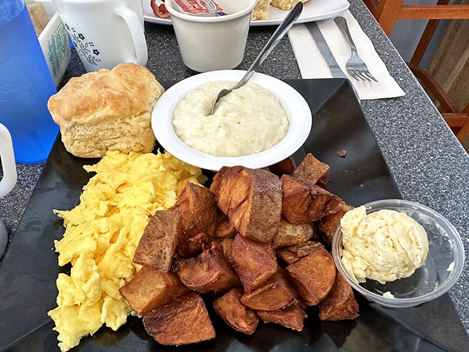 The breakfast plate that launched a thousand satisfied sighs—eggs, sausage patties, and gravy that could make you relocate to St. Augustine.
