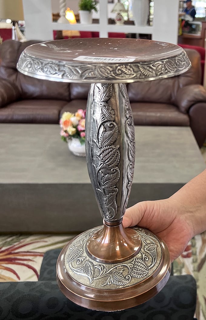 This ornate silver pedestal table isn't just furniture; it's a conversation piece waiting to upstage everything else in your home.