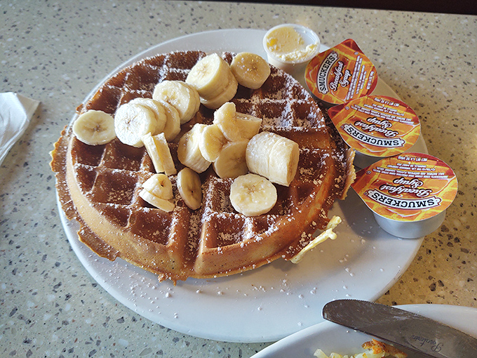 A waffle wearing banana slices like a crown. Royalty of the breakfast kingdom, ready for its maple throne.