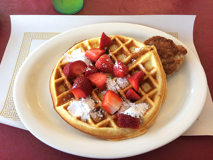 A waffle that's dressed for success with fresh strawberries and powdered sugar, proving that sometimes the classics need very little improvement.