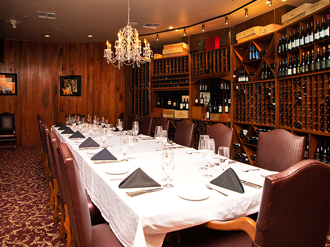 The wine room whispers sophistication while promising perfect pairings for whatever magnificent beef adventure awaits your palate.