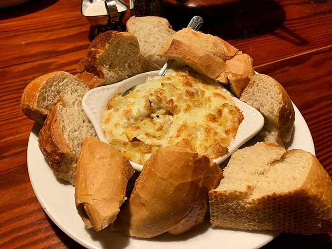This artichoke dip surrounded by fresh bread isn't just an appetizer&mdash;it's the opening act that threatens to upstage the headliner if you're not careful.