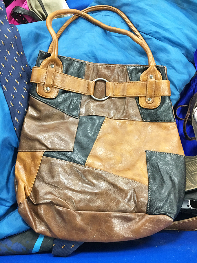 A patchwork leather handbag that tells stories of craftsmanship. At traditional retail, this beauty would command your entire lunch budget for a month.