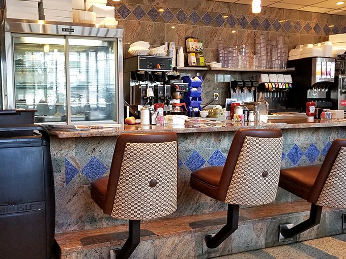 The classic diner counter offers front-row seats to watch culinary magic happen in the open kitchen.