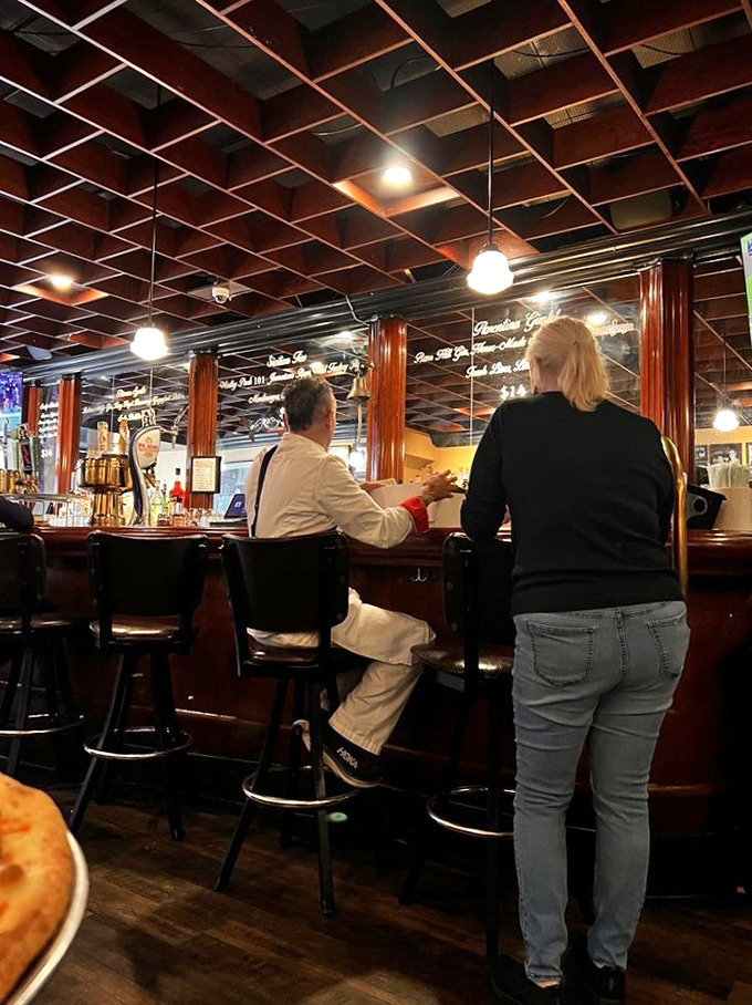 The bar at Tony's isn't just where drinks are served—it's where pizza pilgrimages begin and friendships are forged over shared slices and local brews.