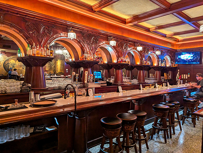 This isn't just a bar &ndash; it's a cathedral to cocktail craftsmanship, where the arched woodwork frames bottles like precious artifacts in a museum of merriment.