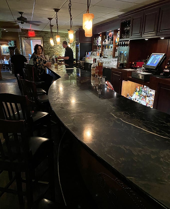 The polished bar invites you to settle in for pre-dinner drinks while anticipating the culinary adventures ahead.