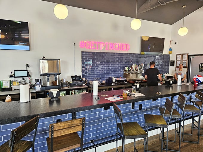 The blue-tiled bar with its neon "GET PINCHED" sign isn't just serving drinks&mdash;it's serving attitude, in the best possible way. This is command central for seafood revelry.