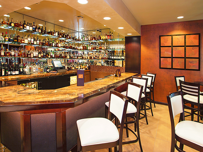 A bar stocked so thoroughly it looks like the United Nations of spirits. Whatever your preferred liquid happiness, they've got it.