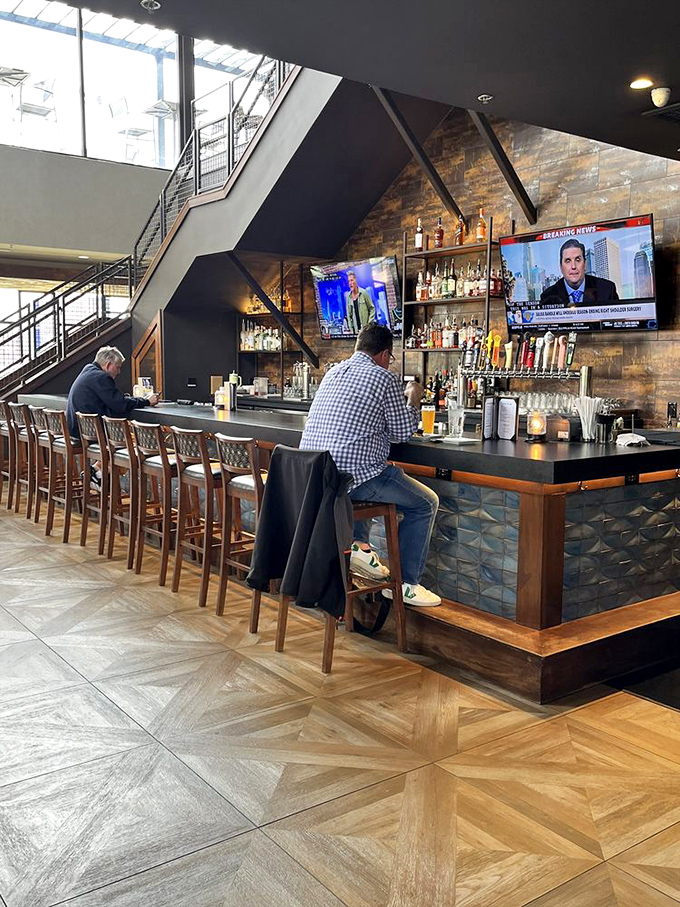 The heart of operations&mdash;a handsome bar where bourbon bottles stand at attention, ready for their starring role in your evening.