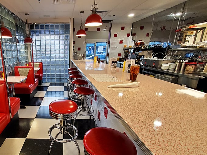 The counter seating offers front-row tickets to the culinary show, where short-order cooking becomes performance art.