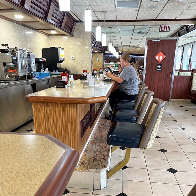 The classic diner counter where solo diners become part of the community conversation naturally.