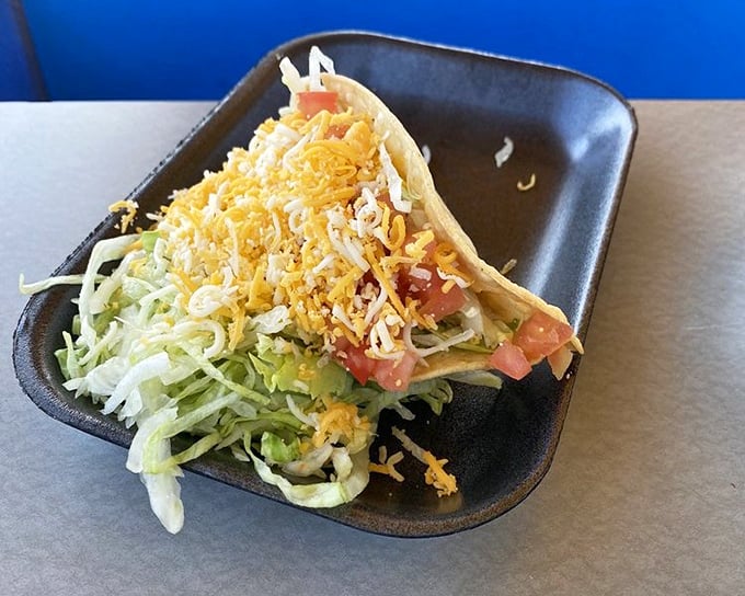 A beef taco so loaded with cheese, it's practically wearing a golden crown of deliciousness. 