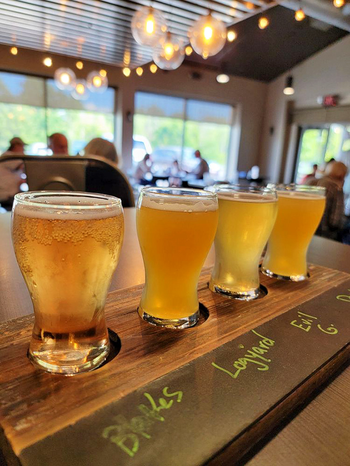 A wooden flight of liquid gold—four different craft beers lined up like beauty contestants, each hoping to win your heart.