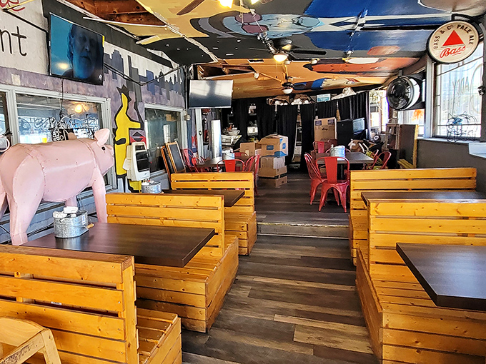 Wooden booth seating that's seen thousands of satisfied customers, with that pink pig statue standing guard over barbecue memories in the making.
