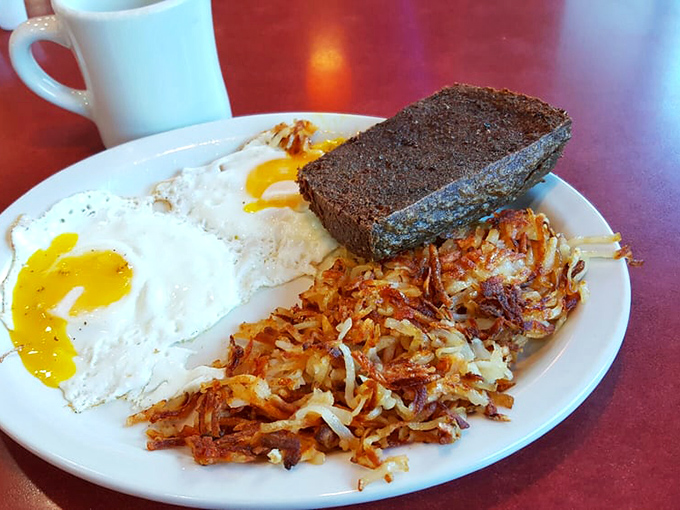 The breakfast trinity: sunny-side up eggs, hash browns with perfect crispy edges, and scrapple that out-of-towners fear but locals treasure.