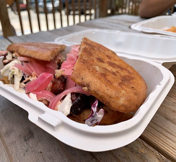 Pink pickled onions add a pop of color to this sandwich masterpiece, like Miami art deco buildings against a sunset sky.