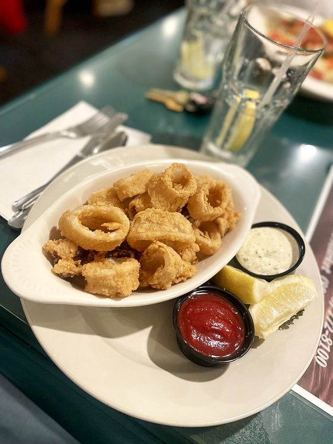 Calamari rings fried to golden perfection, with dipping sauces standing by. Ocean treasures transformed into finger food royalty.