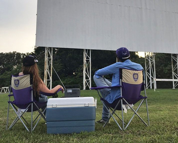 The perfect setup: camping chairs, cooler, and anticipation. These moviegoers have elevated the drive-in experience to an art form.