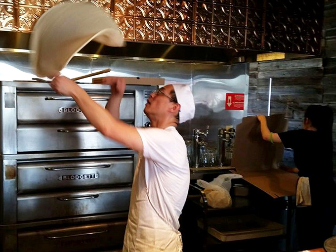 Behind every great pizza is a passionate chef, transforming simple dough into edible art with practiced hands and focused concentration.