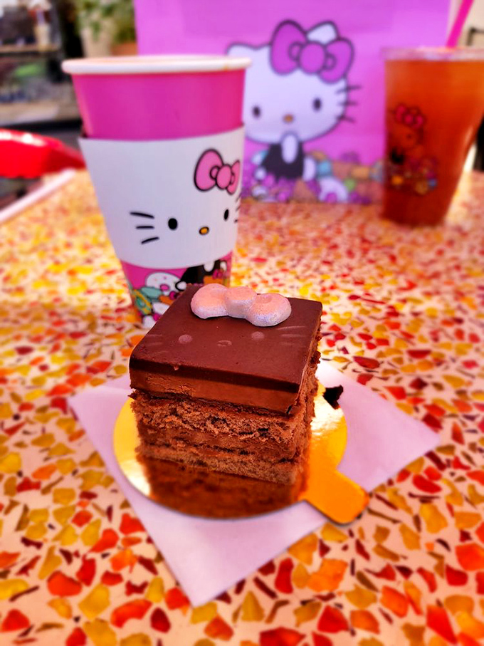 Layers of chocolate perfection crowned with a tiny bow – because sometimes the most serious desserts wear the cutest accessories.